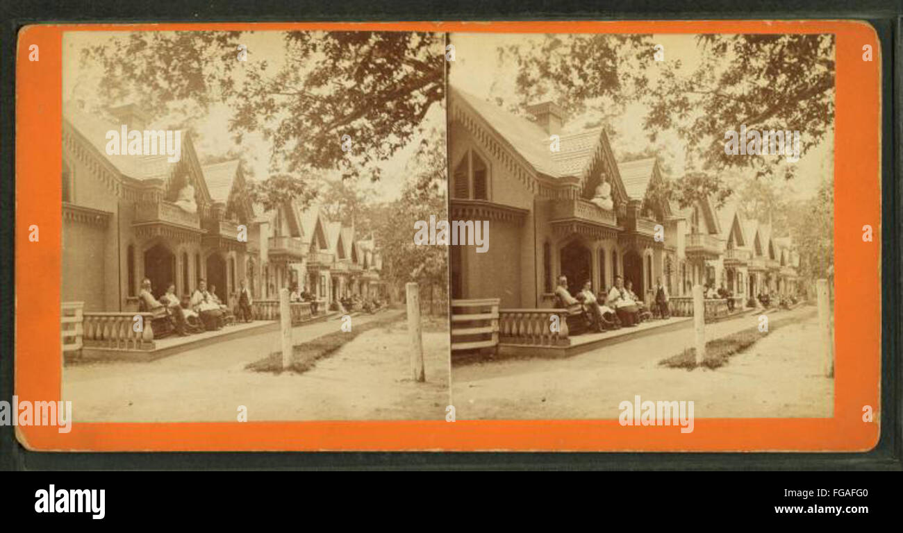 A street of cottages, people in front and on balconies, by R. G. Shute ...