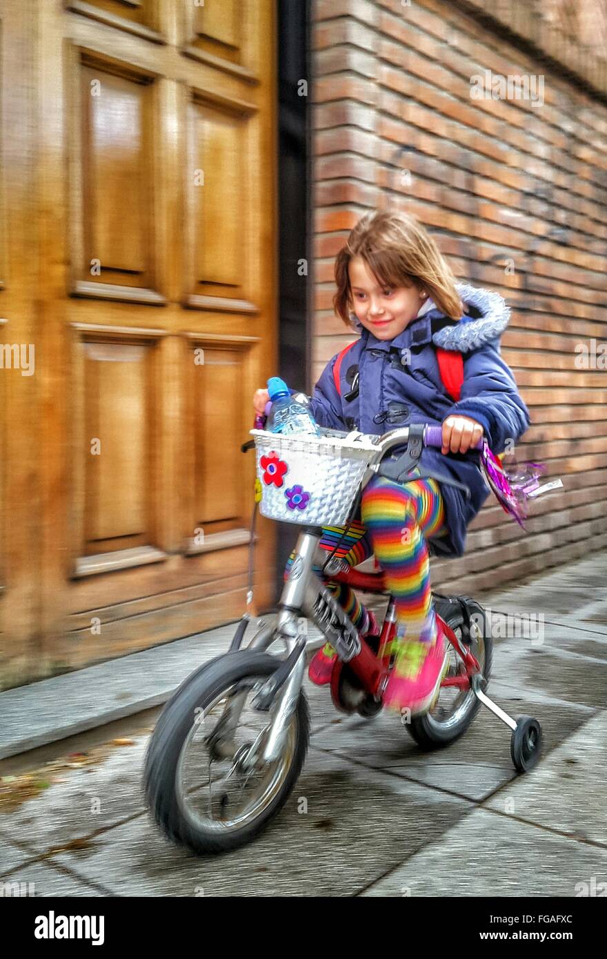 Happy Cute Girl Cycling On Footpath In City Stock Photo - Alamy