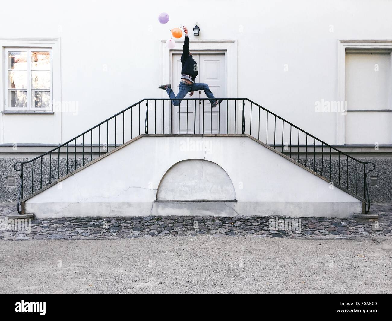 Young man jumping over railing hi-res stock photography and images - Alamy