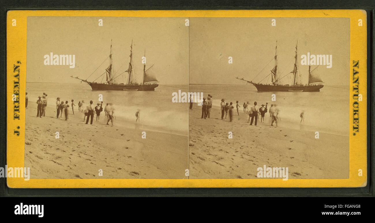 A photograph by Josiah Freeman showing a group of people on the shore ...