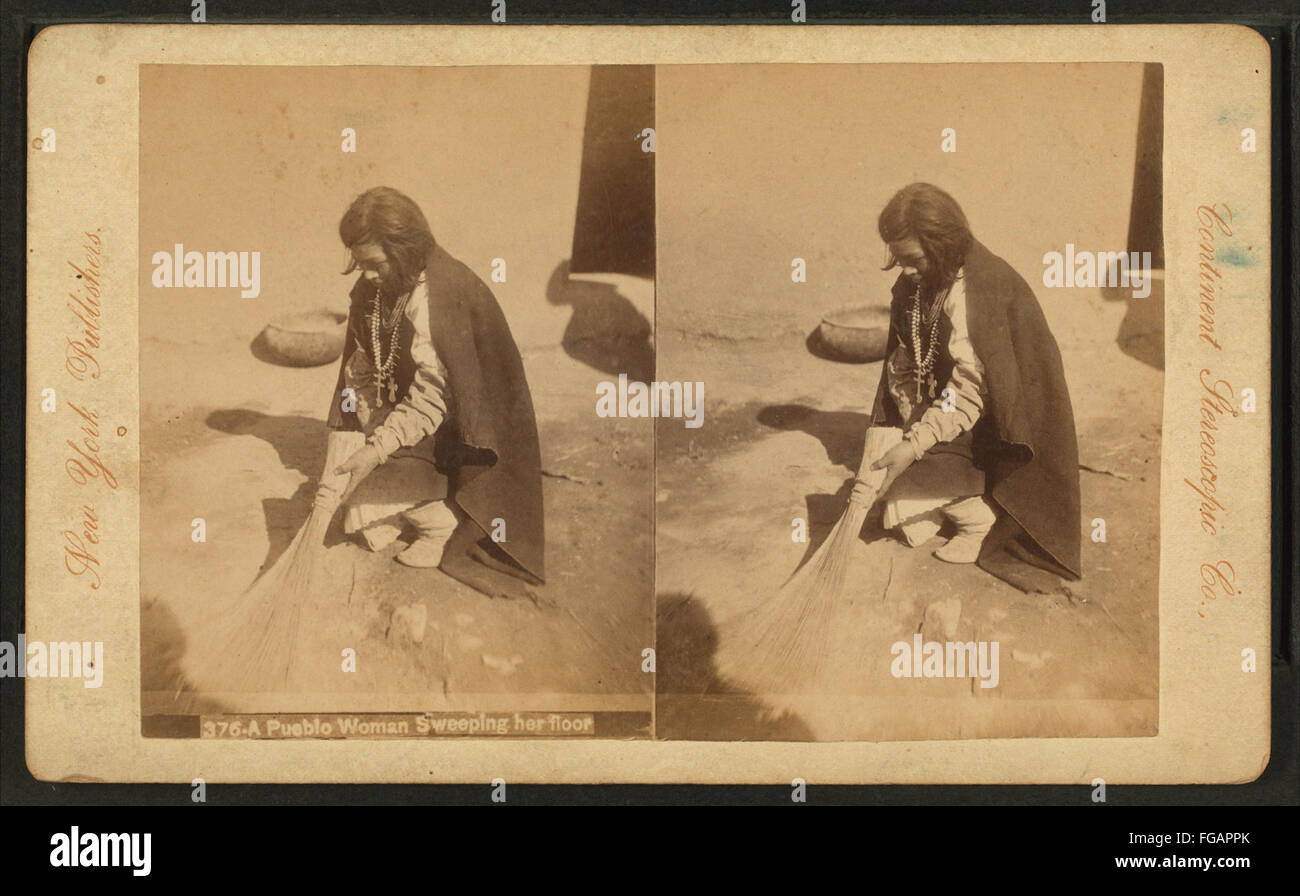 A photograph depicting a Pueblo woman sweeping the floor inside her ...