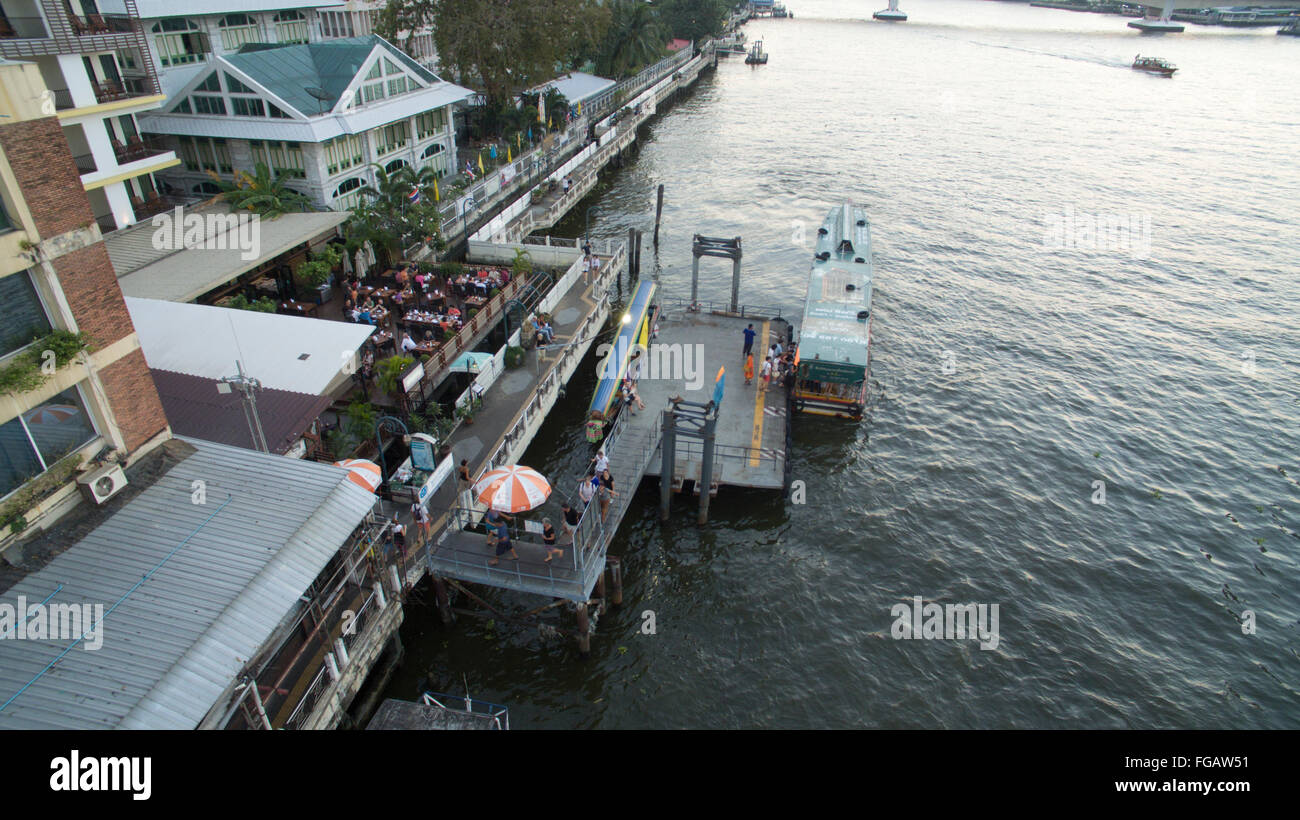 A aerial view above the Chao Phraya River and Phra Athit dock at sunset ...