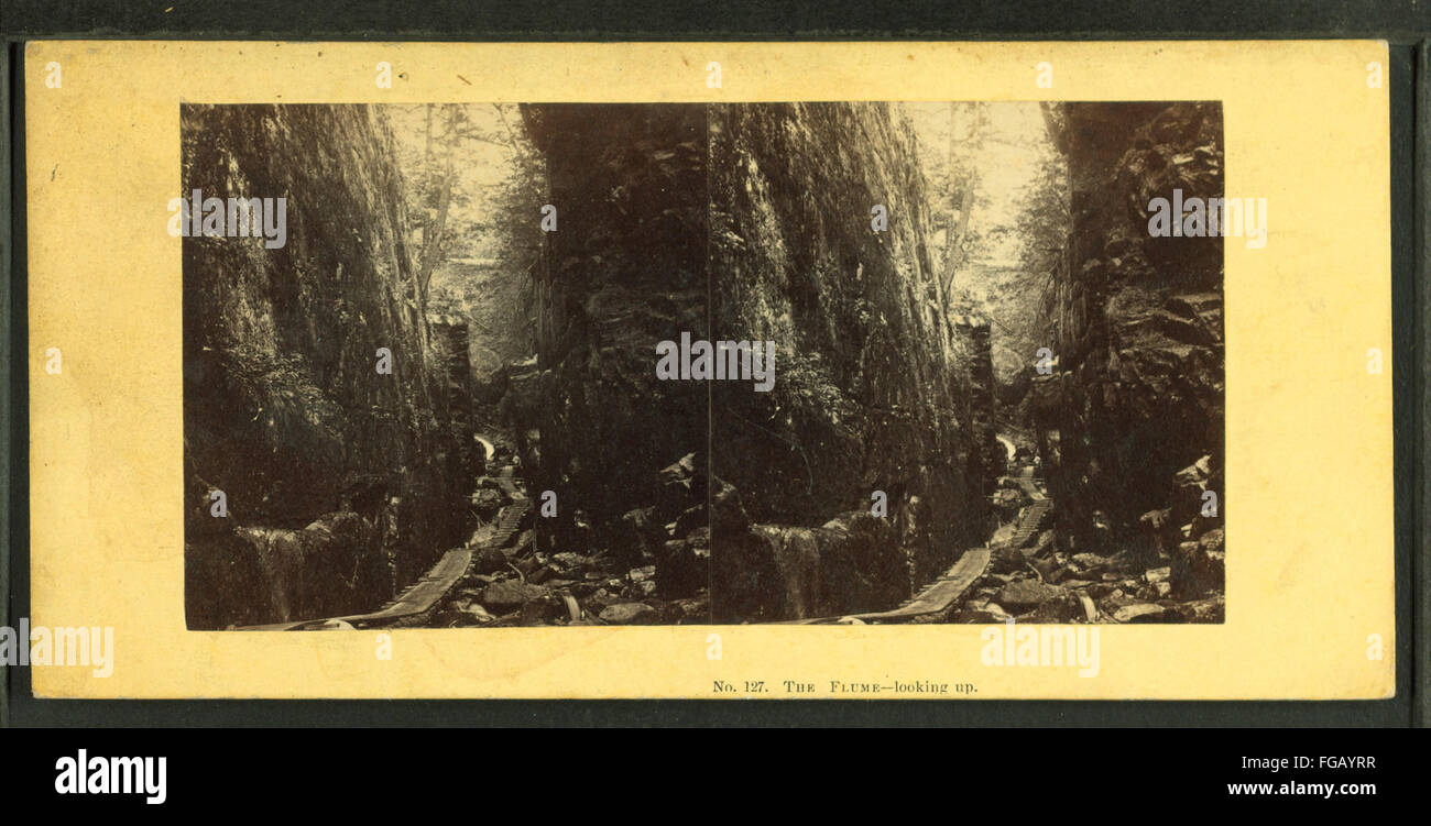 A photograph looking up at The Flume, a natural rock formation ...