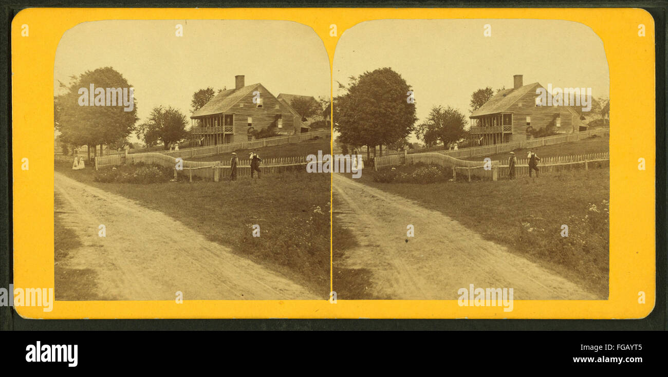 Photograph of a block house surrounded by fences, reflecting the ...