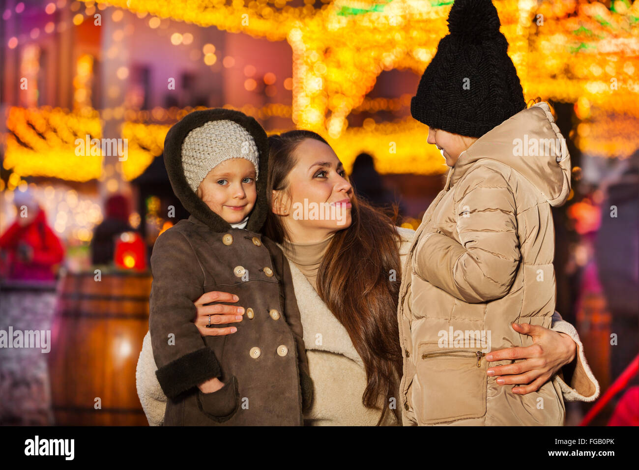 Mother hugging her two beautiful daughters Stock Photo - Alamy