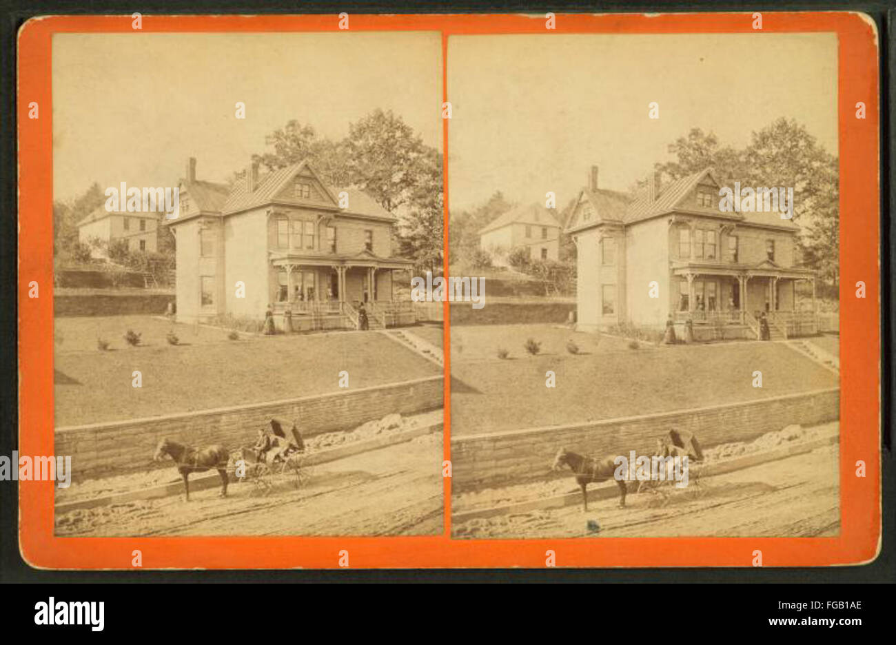 This photograph by L. Hensel captures a three-story frame house with a ...