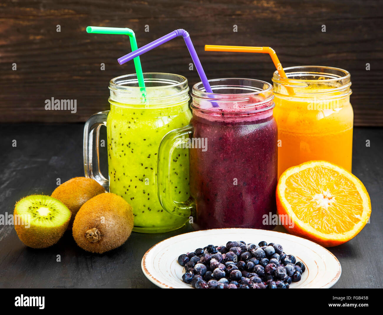 Healthy fruit juices with green kiwi,blueberries and orange Stock Photo ...