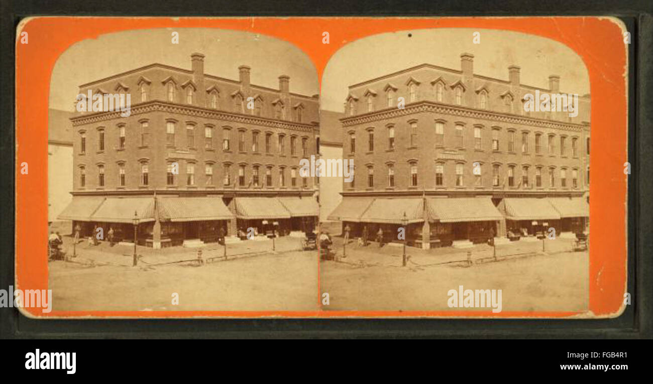 A photograph of a commercial block showing stores on street level, with ...