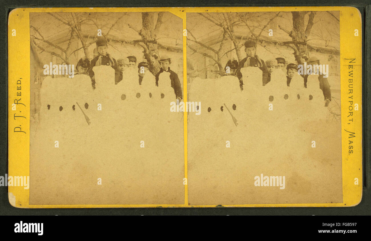 A photograph by D.T. Reed showing a group of boys behind a snow fort ...