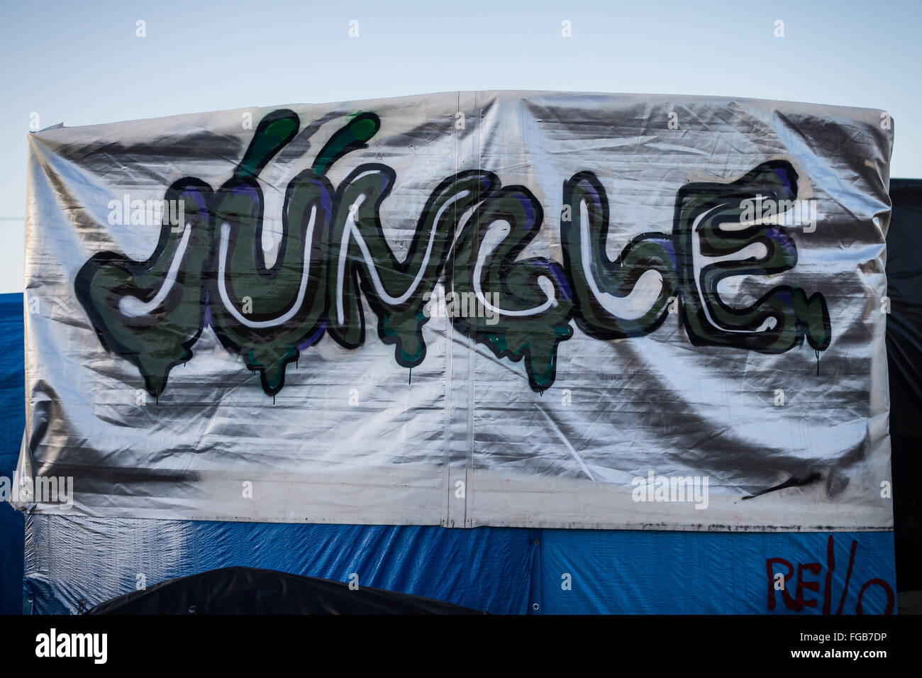 A sign reading 'Jungle' on the side of a makeshift shelter in the ...