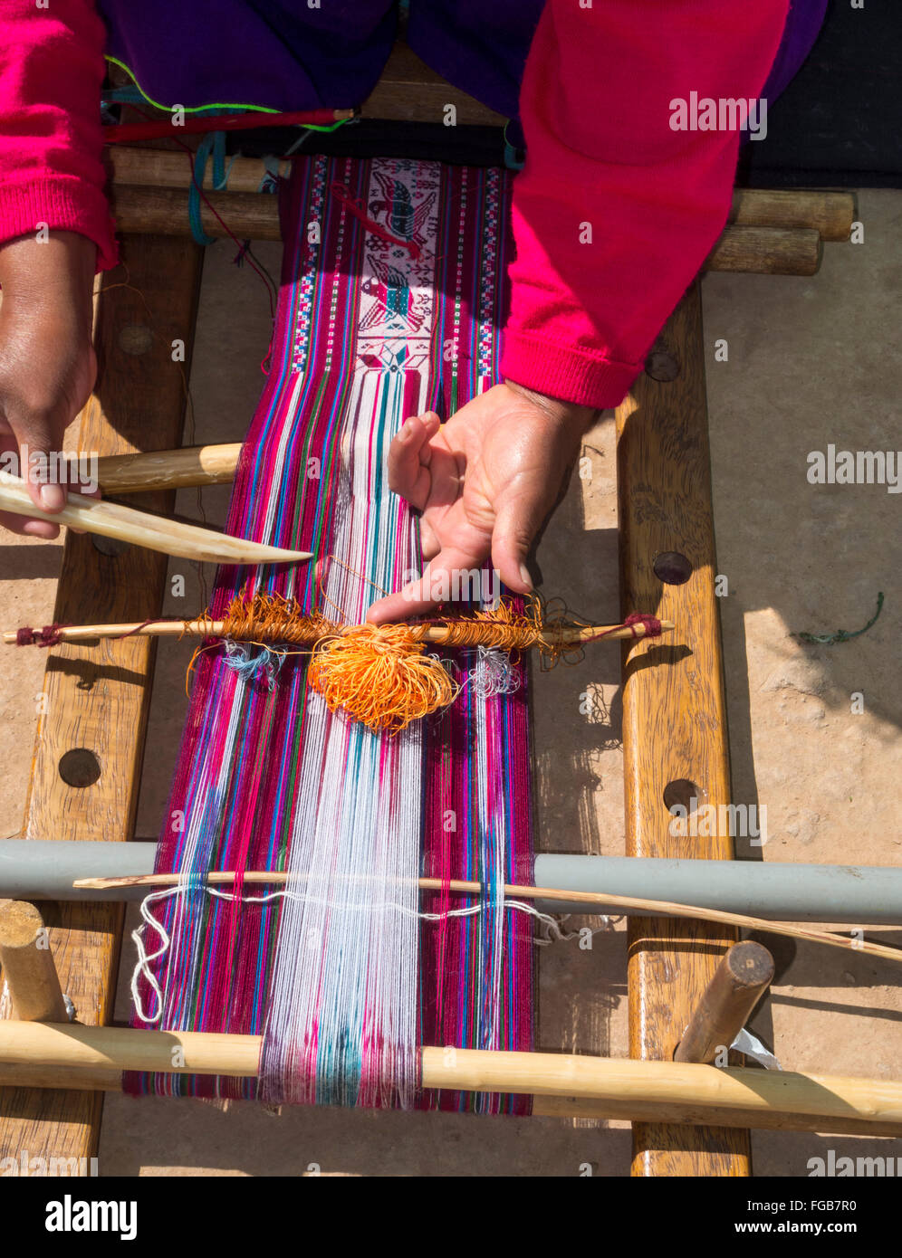 Woman using traditional loom to weave cloth Stock Photo - Alamy