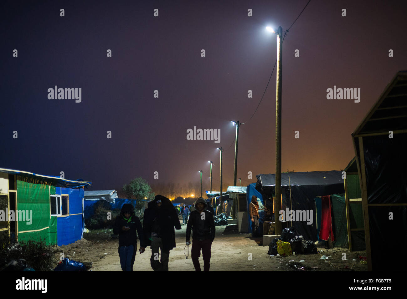 Migrants and Refugees walk through the Jungle Refugee Camp in Calais at ...