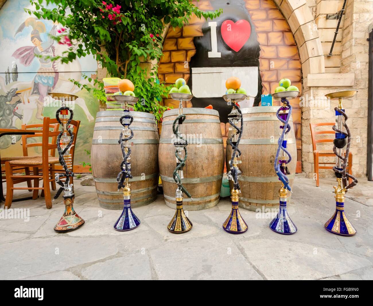 Six shisha, aka nargile or hookah at a restaurant with fruit on top. A ...