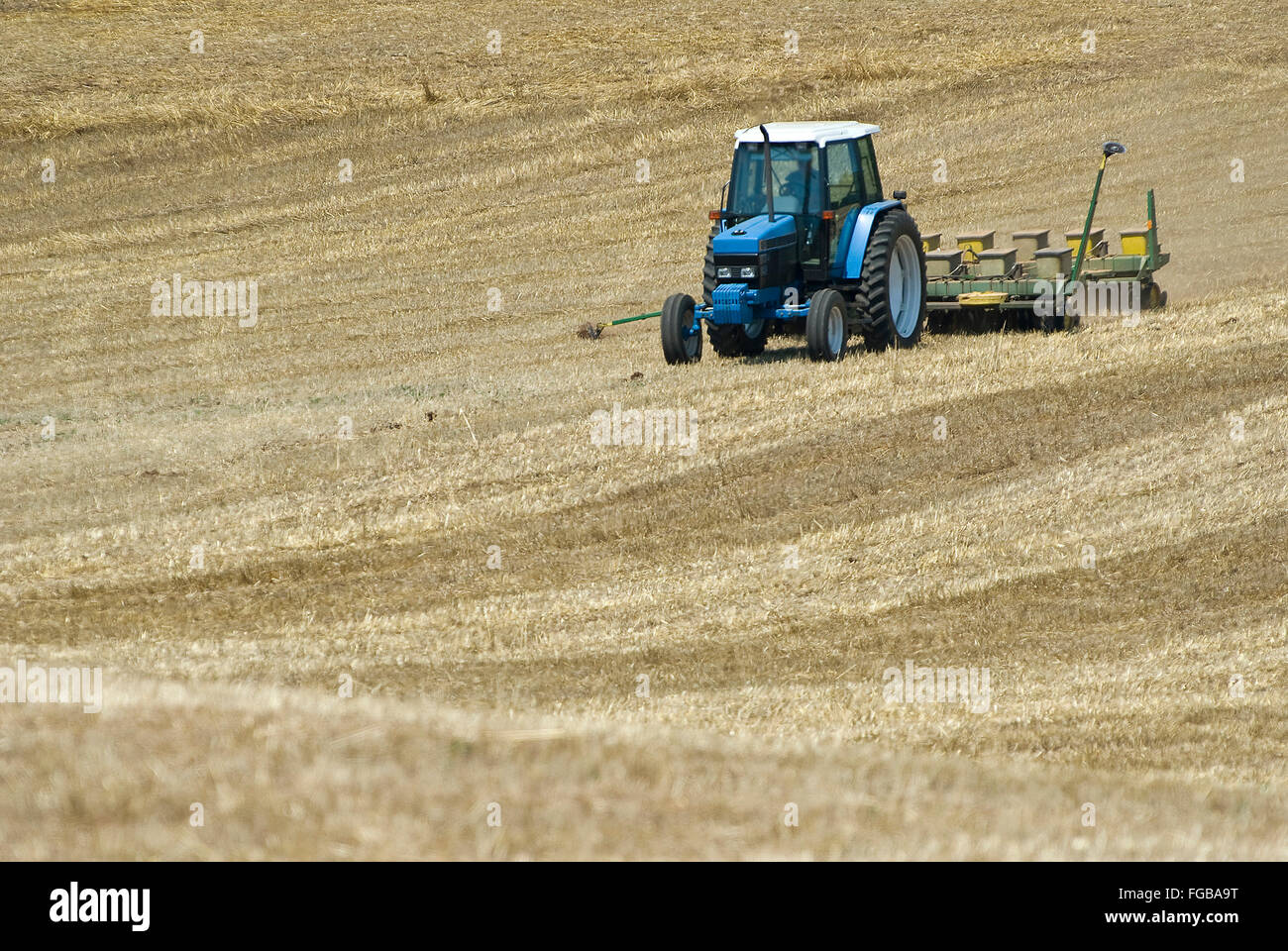Blue tractor seeding field hi-res stock photography and images - Alamy