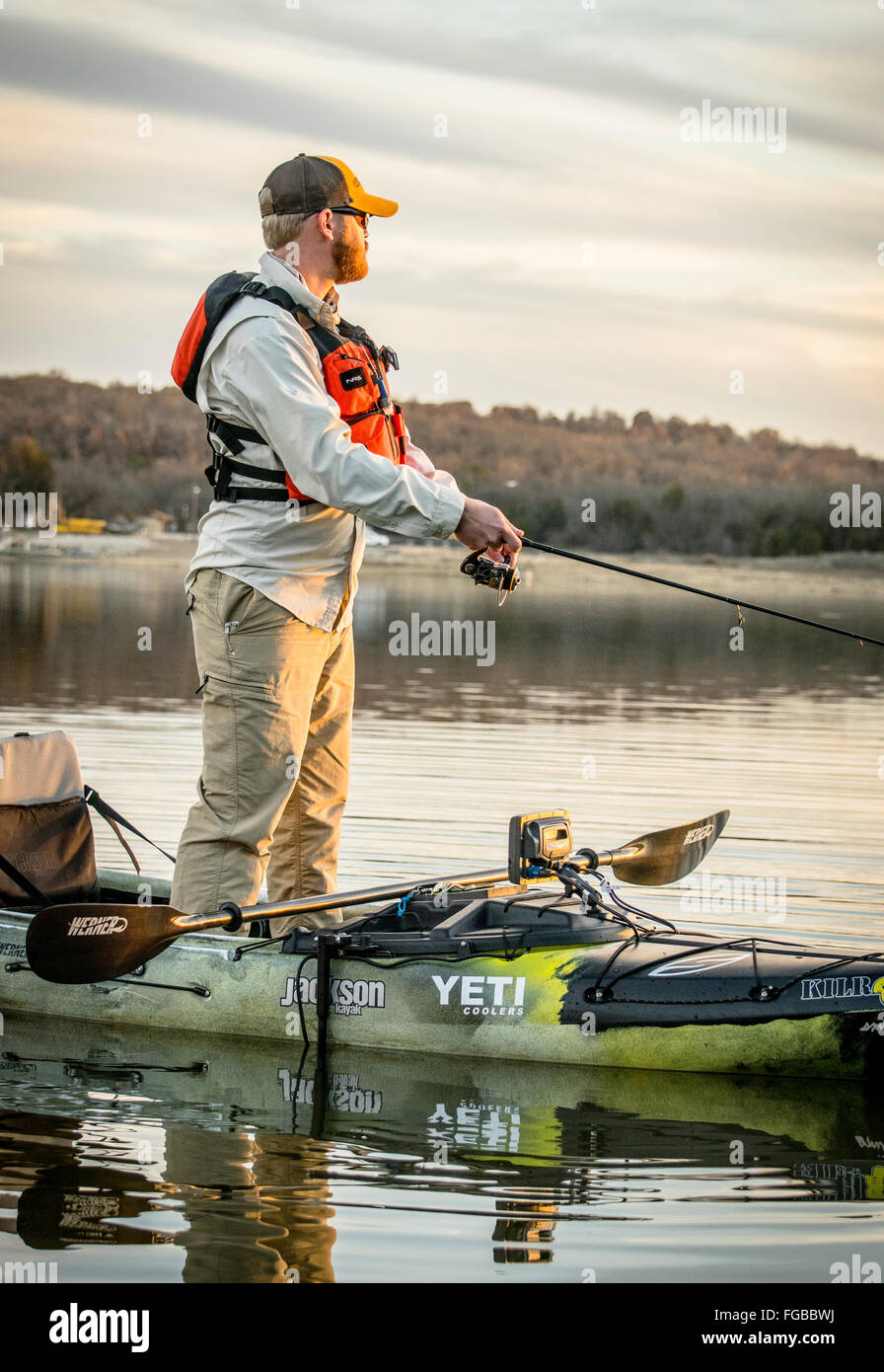 Standing and kayak fishing Stock Photo - Alamy