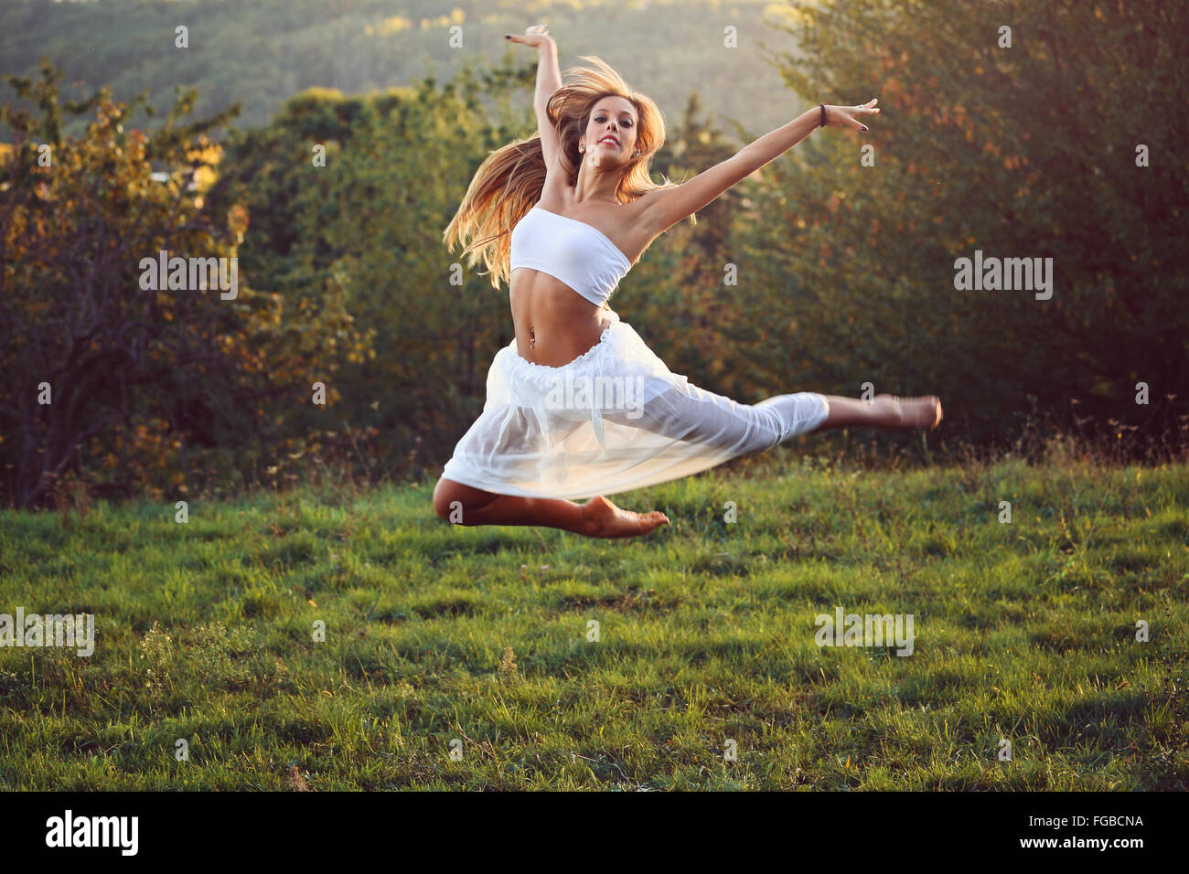 Beautiful classical dancer jumping in sunset light . Outdoor shot Stock ...