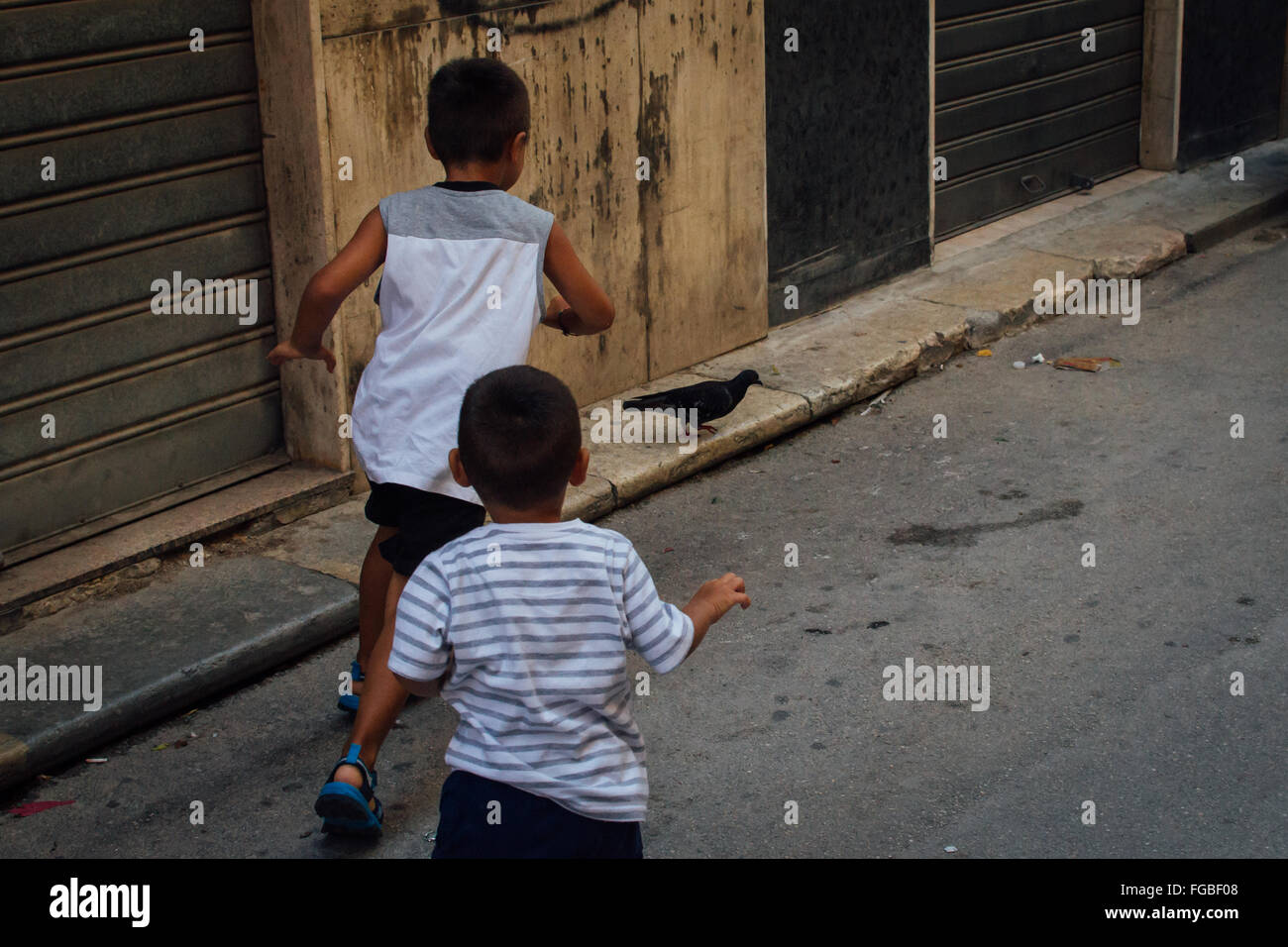 Rear View Of Boys Playing On Street Stock Photo - Alamy