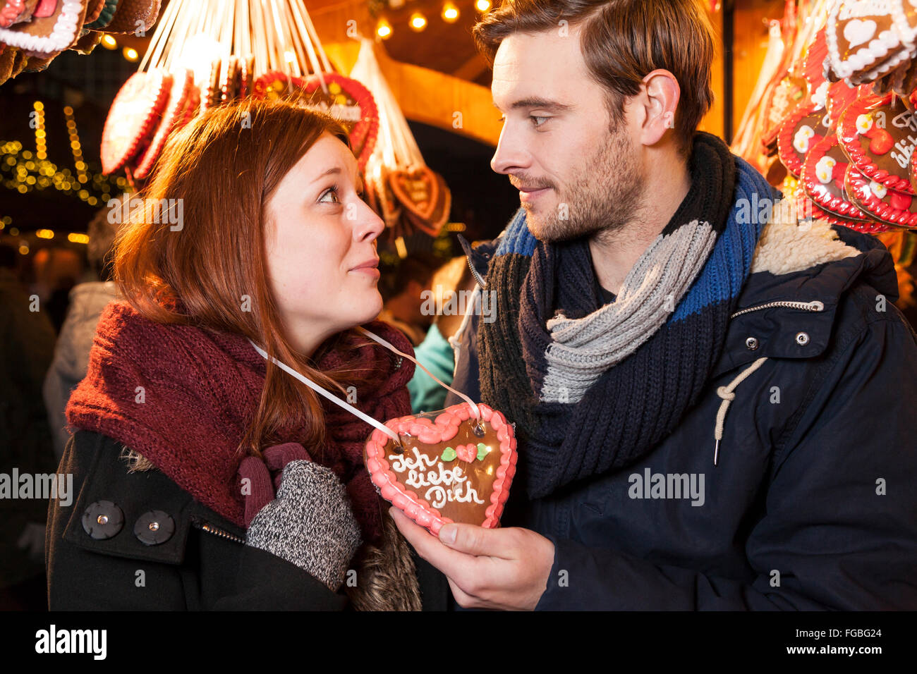 man is giving a german gingerbread heart on christmas market Stock ...