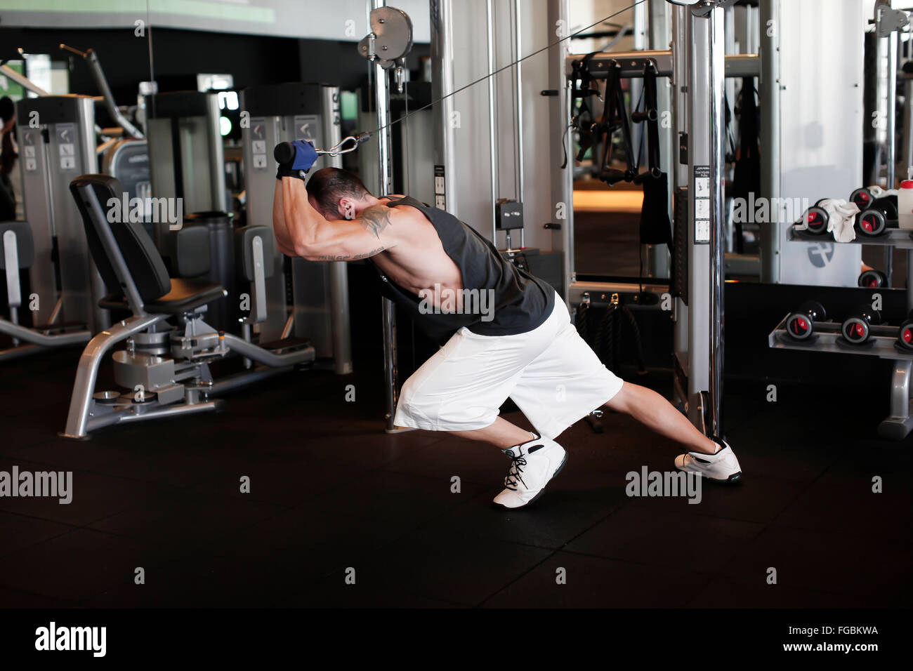 muscular man doing exercise at the gym Stock Photo - Alamy