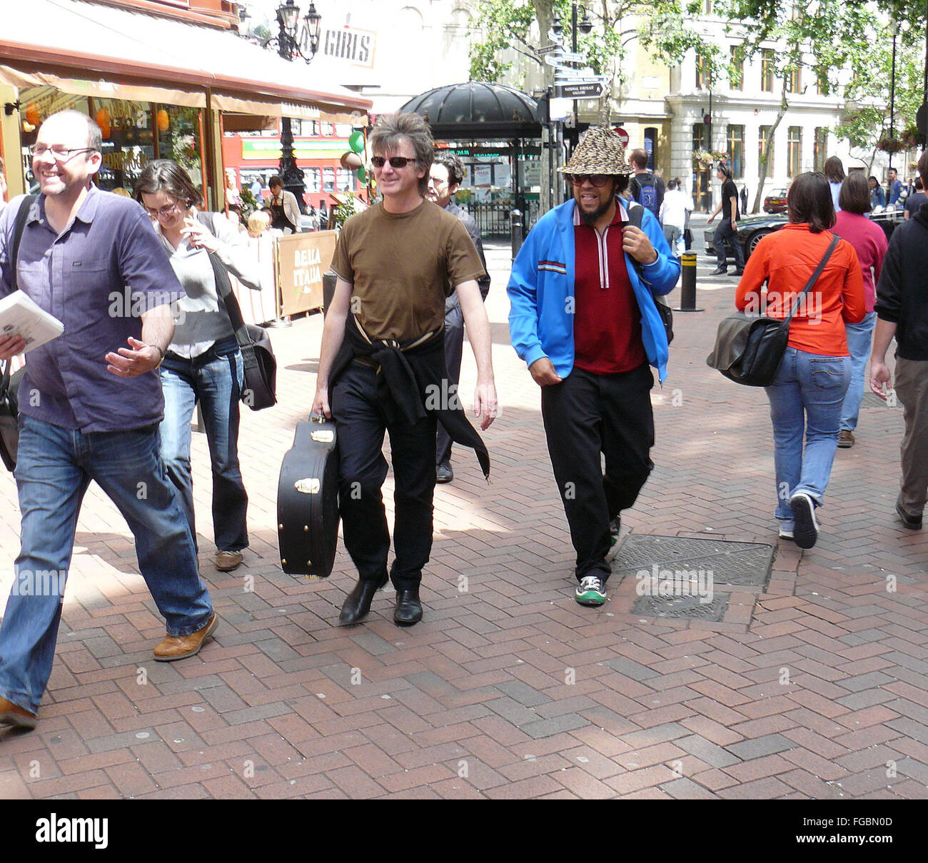 Neil Finn walking with his Guitar in Londons Sunny West end (credit ...
