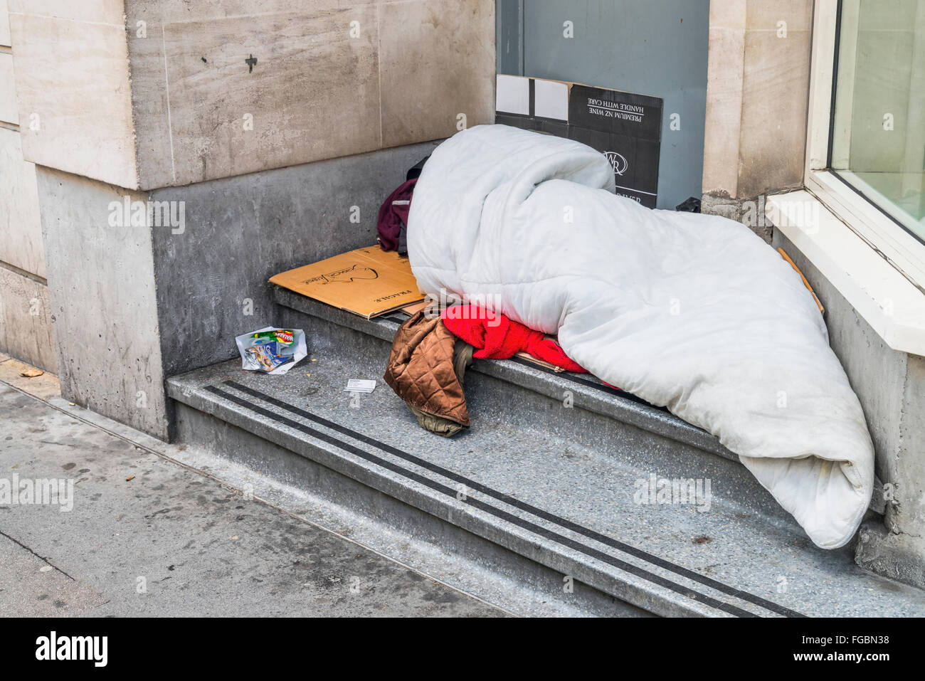 Homeless man sleeping on the street in city Stock Photo - Alamy
