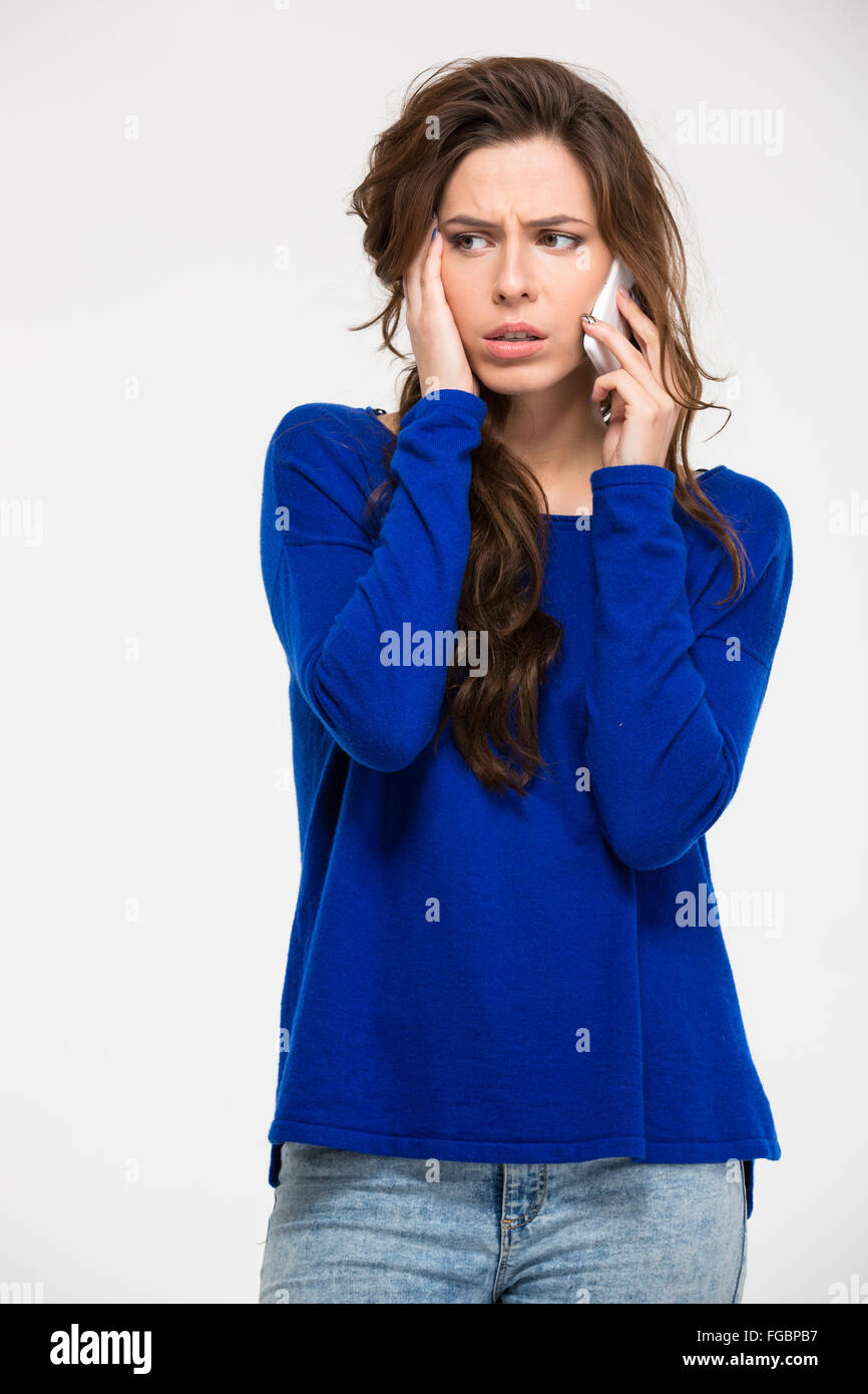Sad woman talking on the phone isolated on a white background Stock ...
