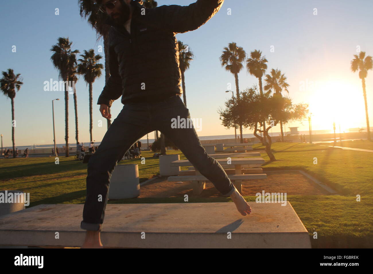 Man Standing On Bench In Park Stock Photo - Alamy