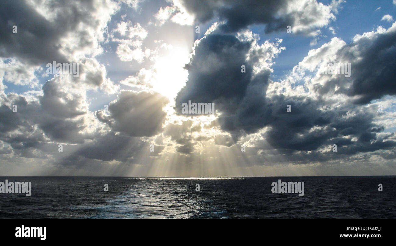 Sunlight beaming through clouds in the Atlantic ocean sunset Stock ...