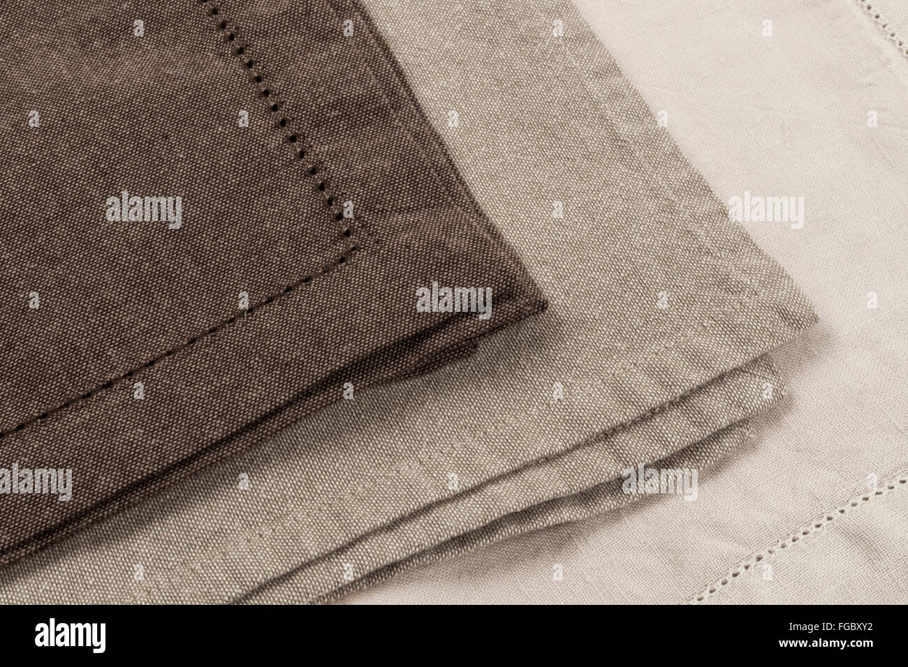 Edges of linen cloth napkins in brown and beige natural colors close up ...