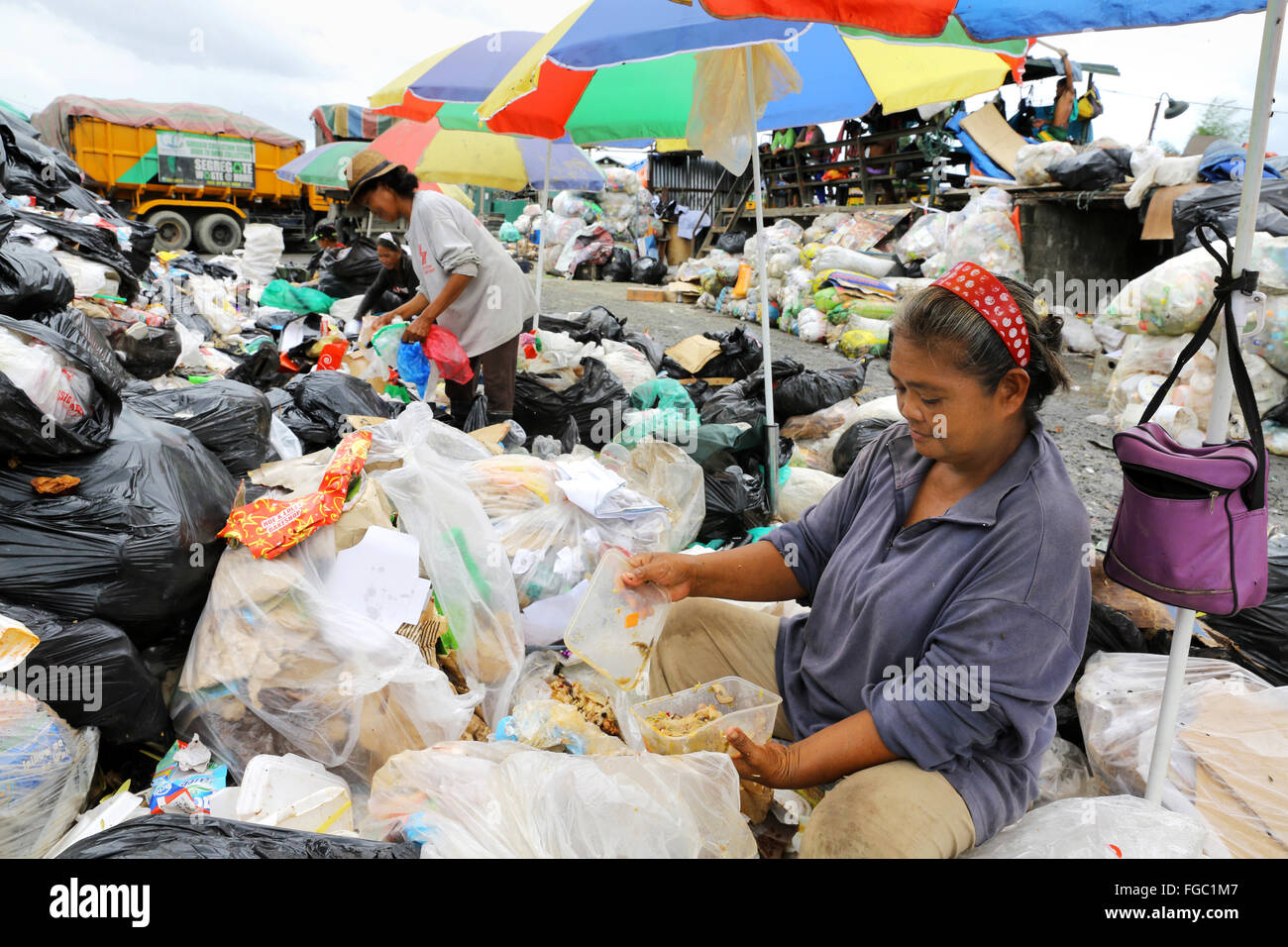 Women work in a waste separation and resale in a Junk Shop near the ...