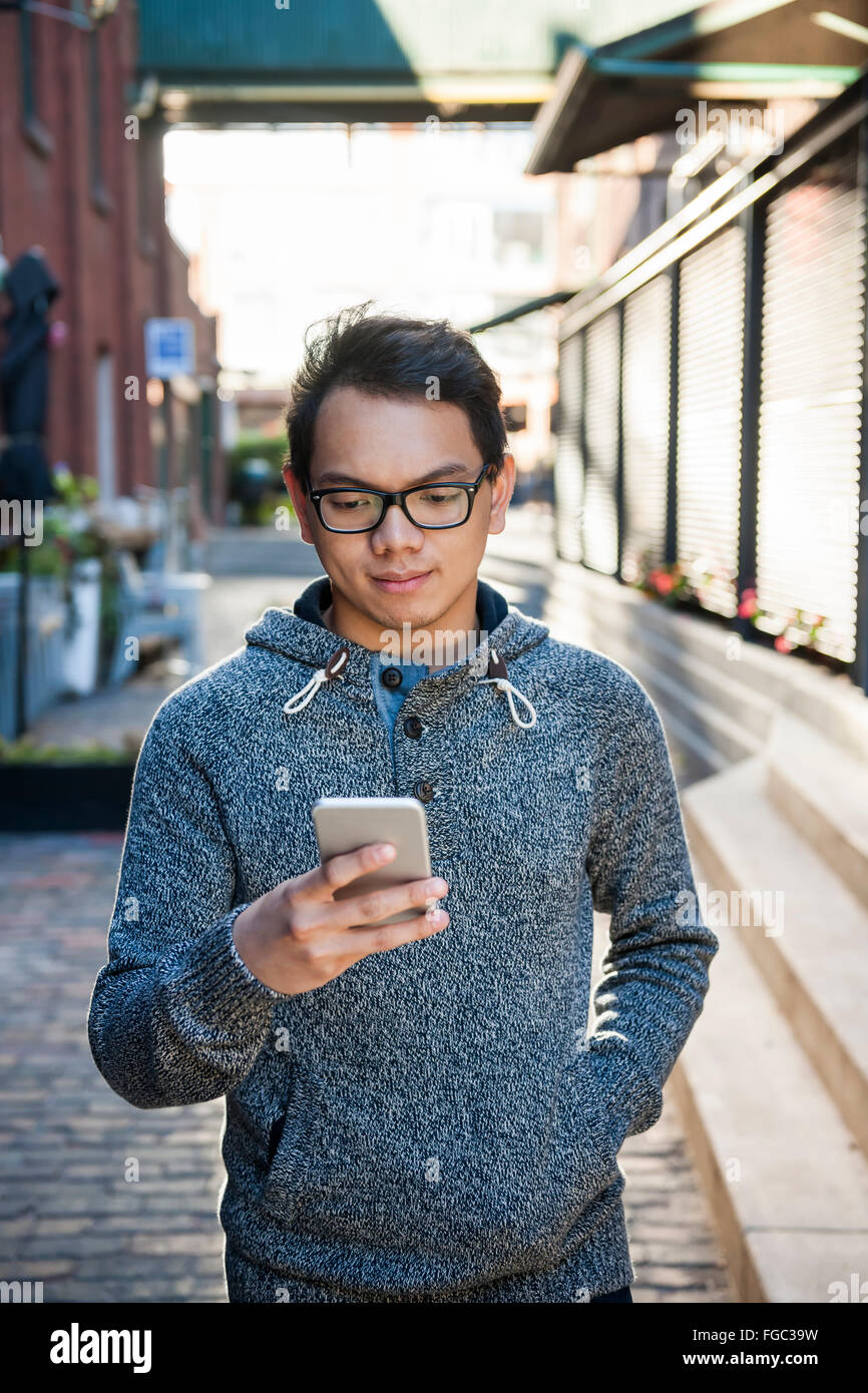 Asian man looking smartphone hi-res stock photography and images - Alamy