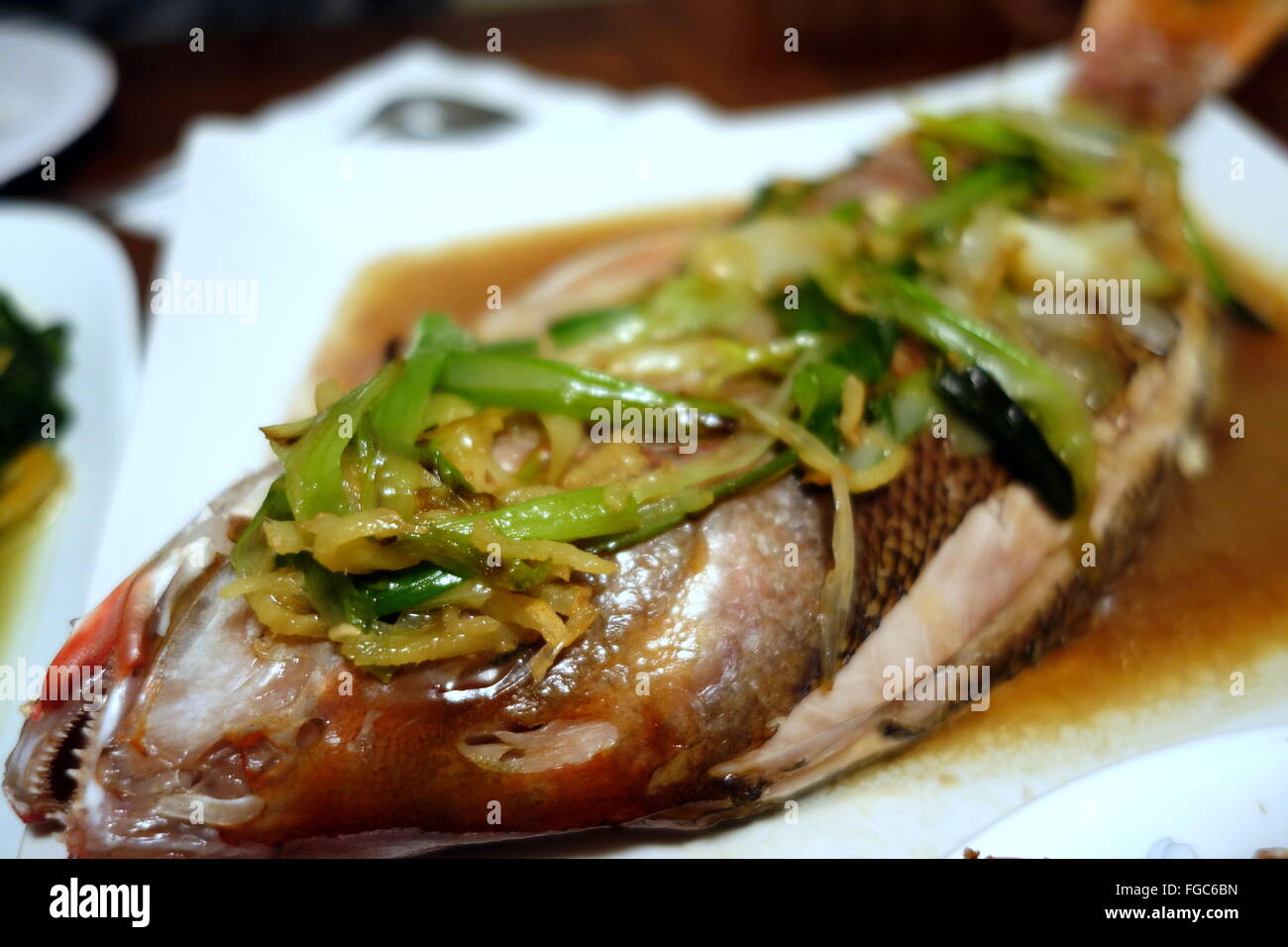 Steamed whole red snapper with ginger and scallion Stock Photo - Alamy