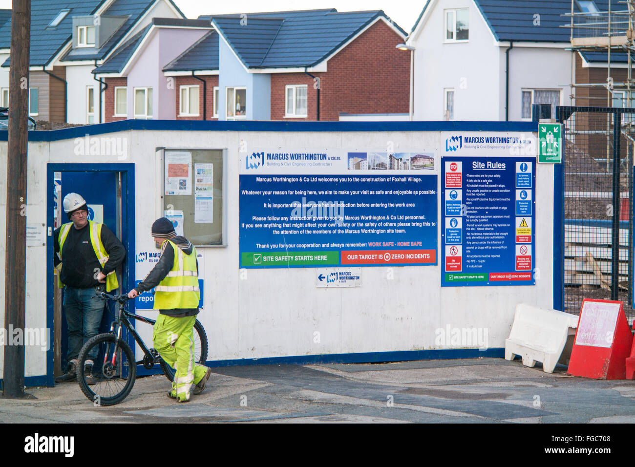 Workmen outside building site Stock Photo - Alamy