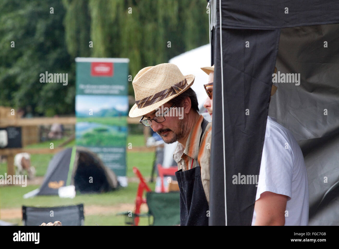 Two men chefs at a music festival food stall Stock Photo - Alamy