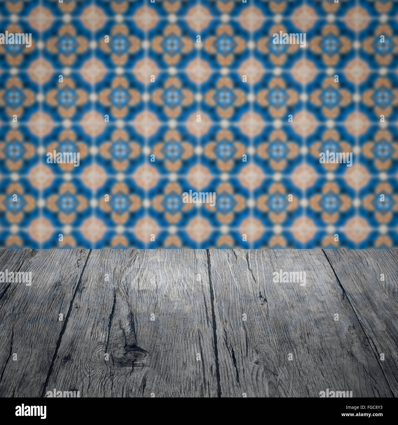 Empty wood table top and blur vintage ceramic tile pattern wall in ...