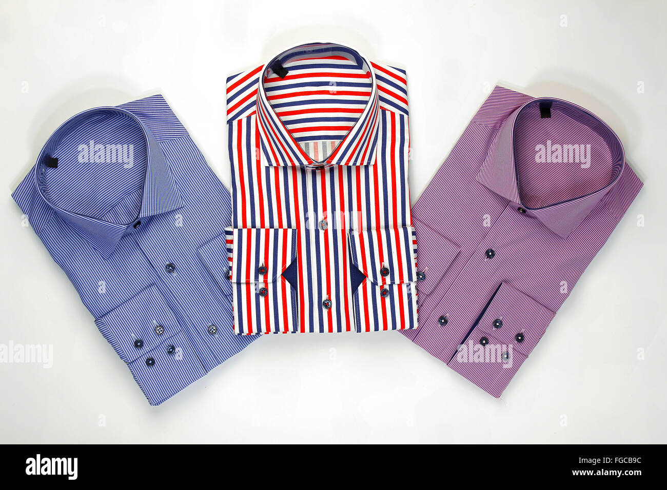 Some colored shirts arranged on white background Stock Photo - Alamy