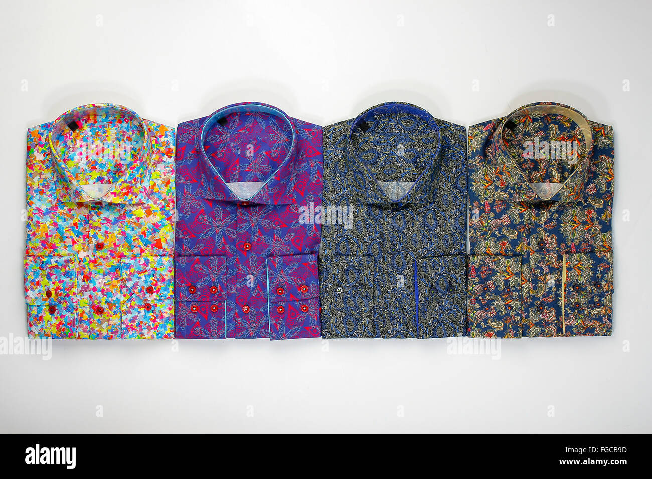 Some colored shirts arranged in a shape on white background Stock Photo ...