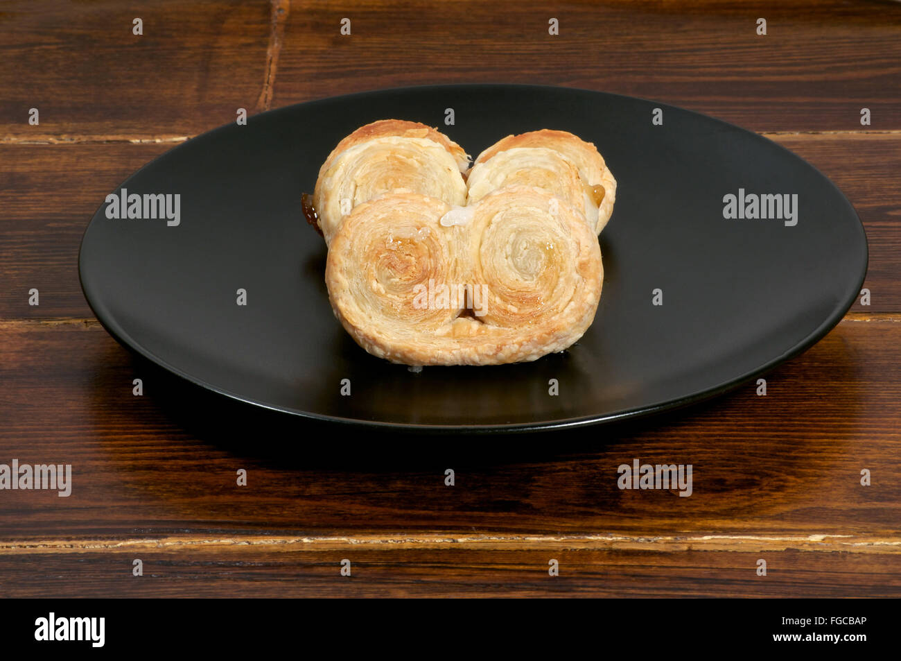 Puff pastry on the place plate over wooden table Stock Photo - Alamy