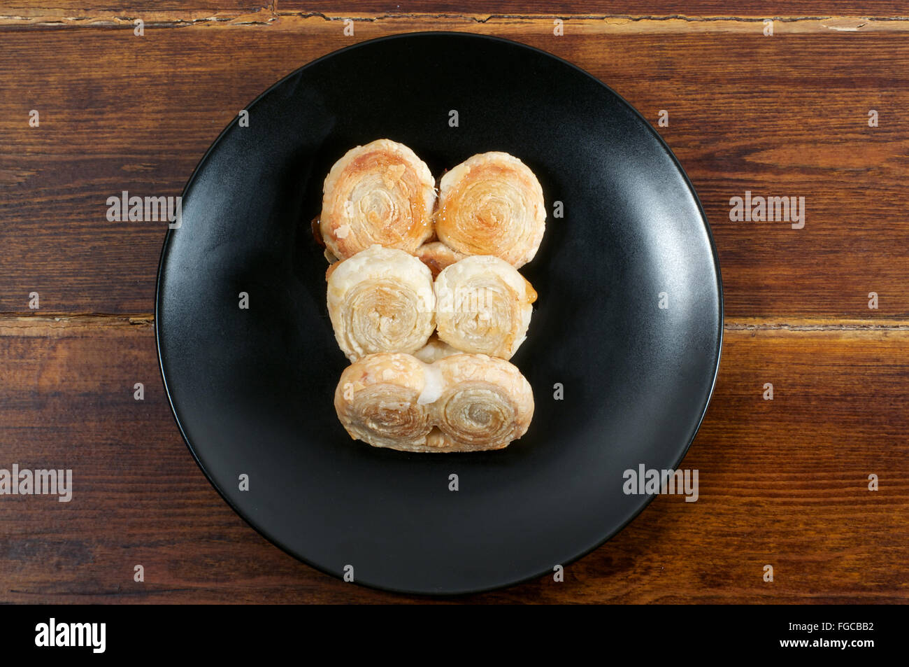 Puff pastry from top on the place plate over wooden table close-up ...