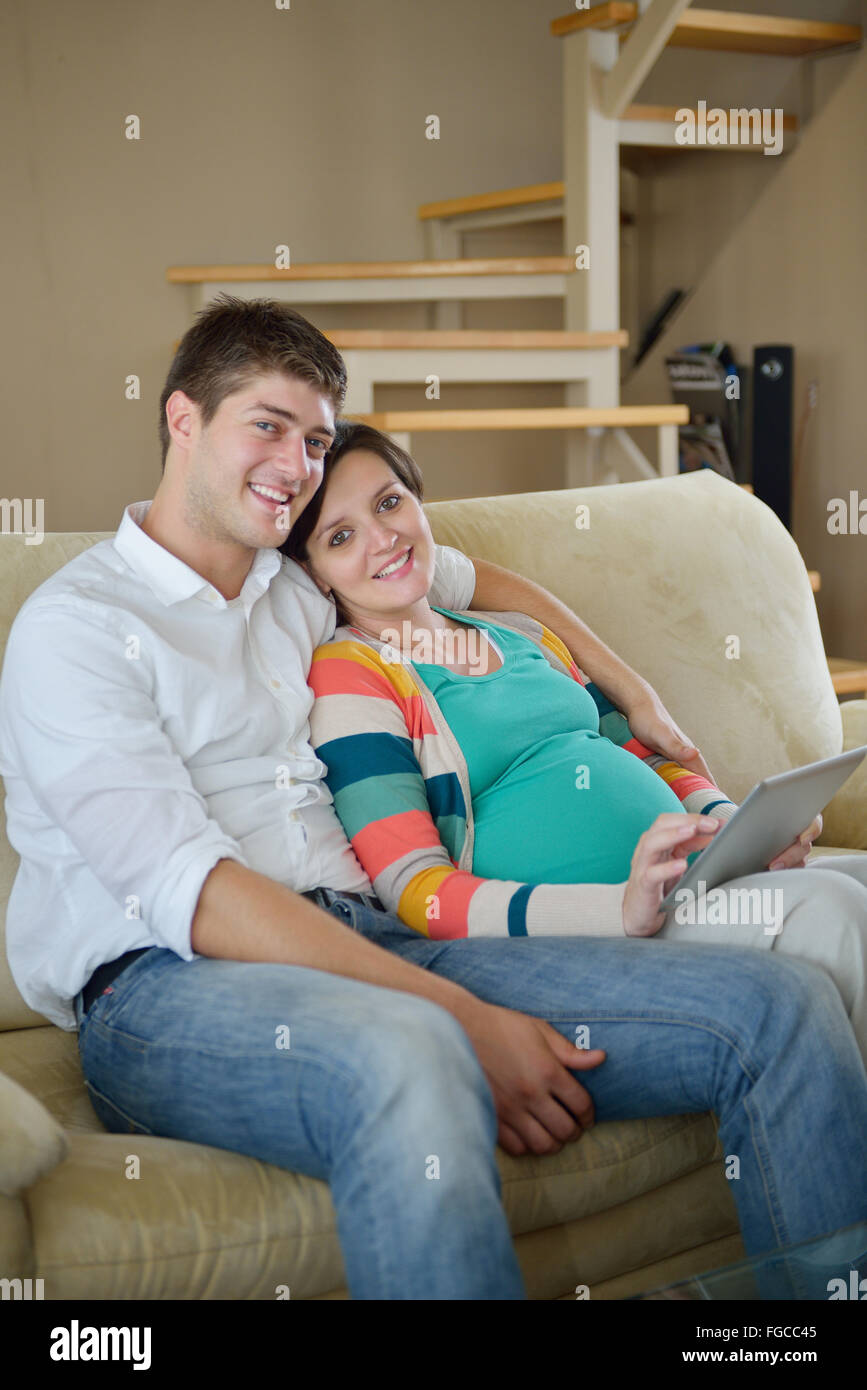 pregnant couple at home using tablet computer Stock Photo - Alamy