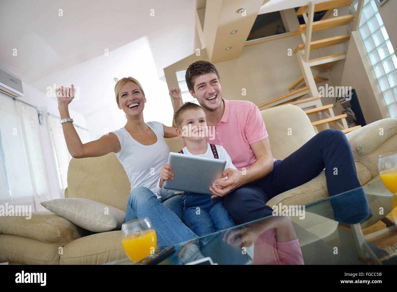 family at home using tablet computer Stock Photo - Alamy