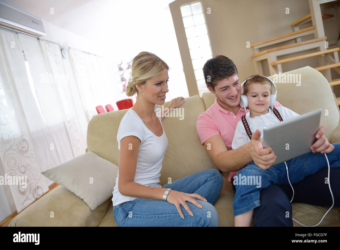 family at home using tablet computer Stock Photo - Alamy