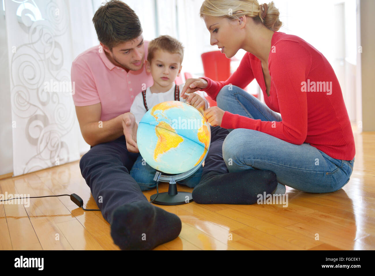 family have fun with globe Stock Photo - Alamy