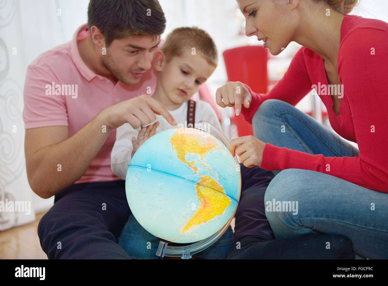 family have fun with globe Stock Photo - Alamy