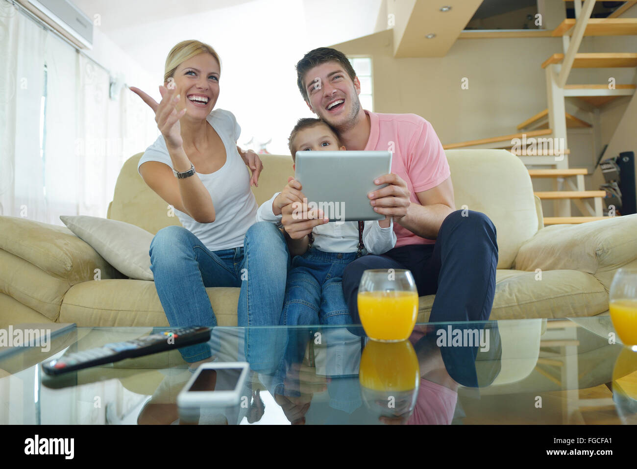 family at home using tablet computer Stock Photo - Alamy