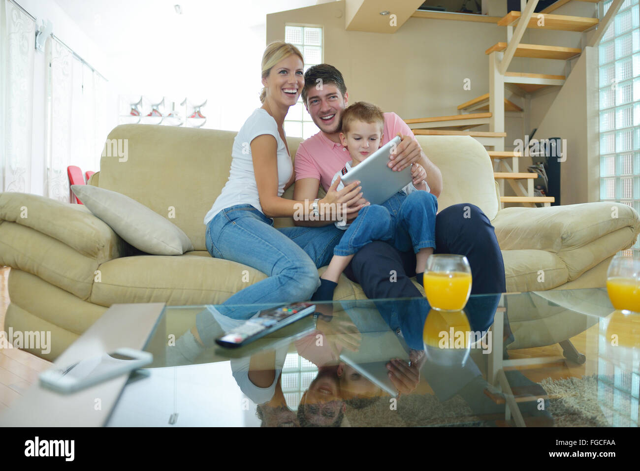 family at home using tablet computer Stock Photo - Alamy
