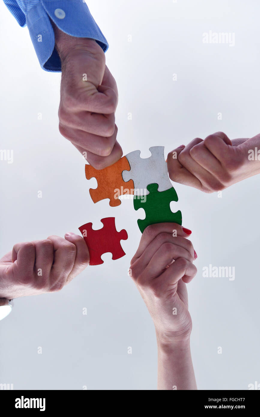 Group of business people assembling jigsaw puzzle Stock Photo - Alamy