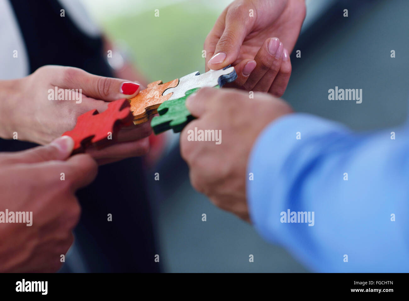 Group of business people assembling jigsaw puzzle Stock Photo - Alamy