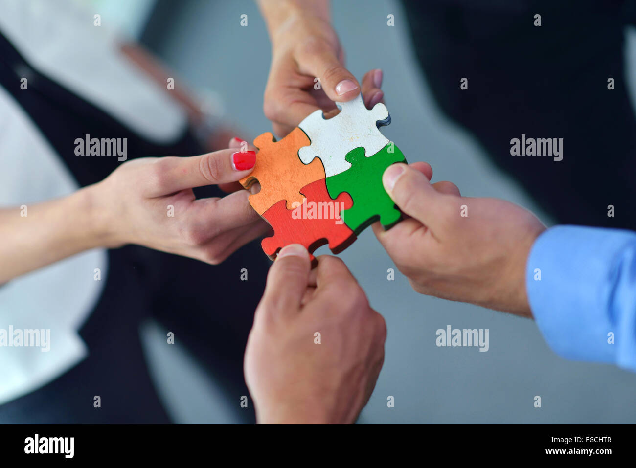 Group of business people assembling jigsaw puzzle Stock Photo - Alamy