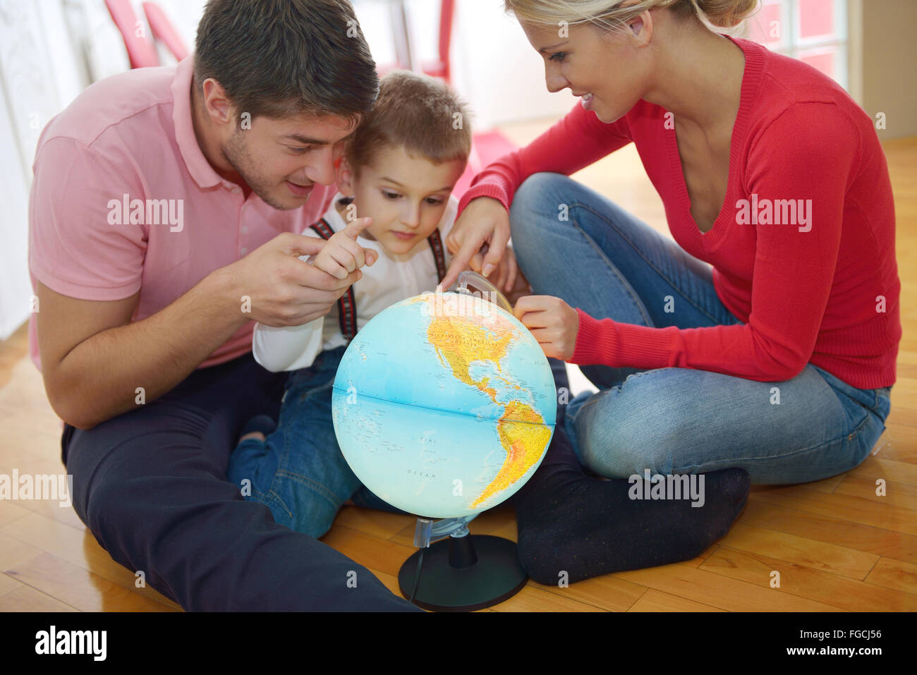 family have fun with globe Stock Photo - Alamy